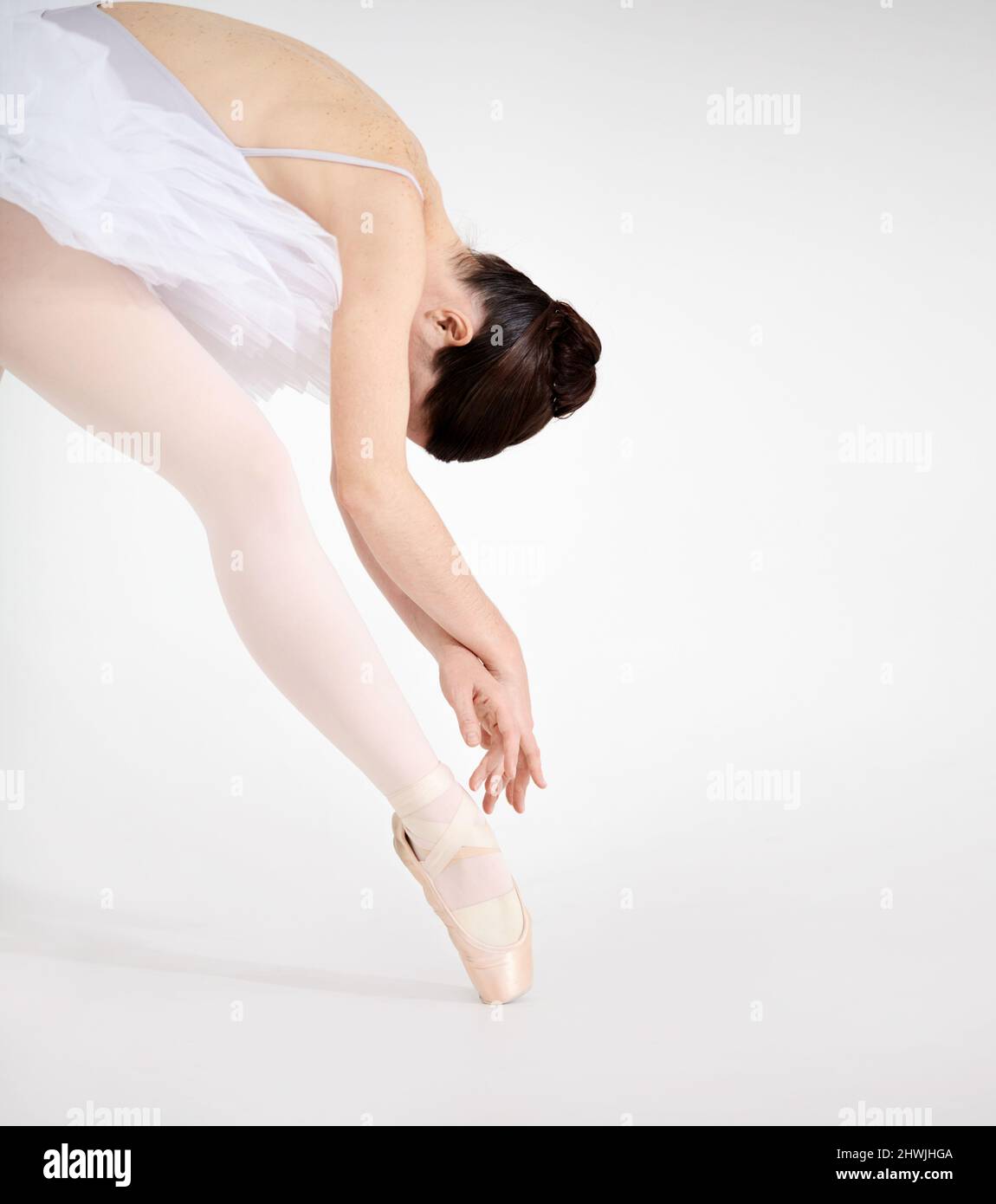 Nothing but elegance. Dedicated young ballerina dancing en pointe ...