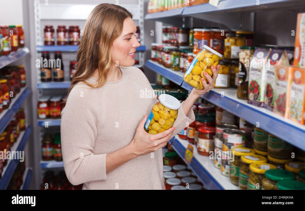 Woman customer choosing pickle goods in the food store Stock Photo - Alamy