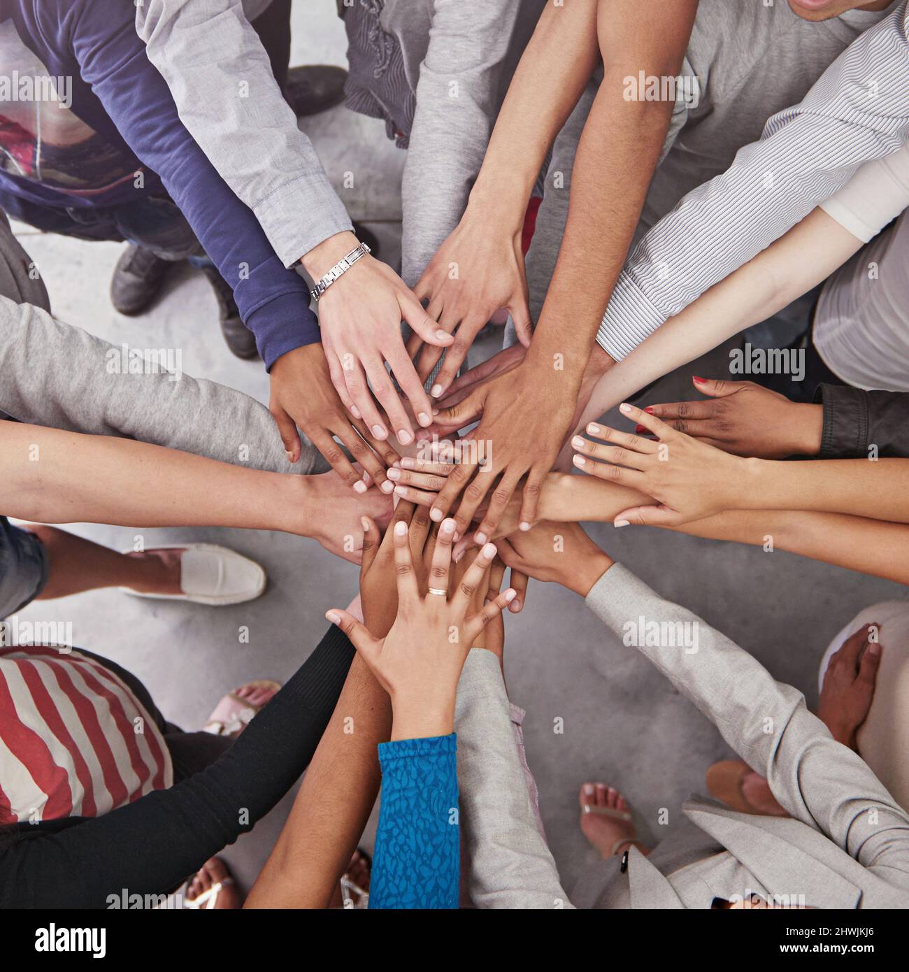 All for one and one for all. Cropped shot of a business team standing ...