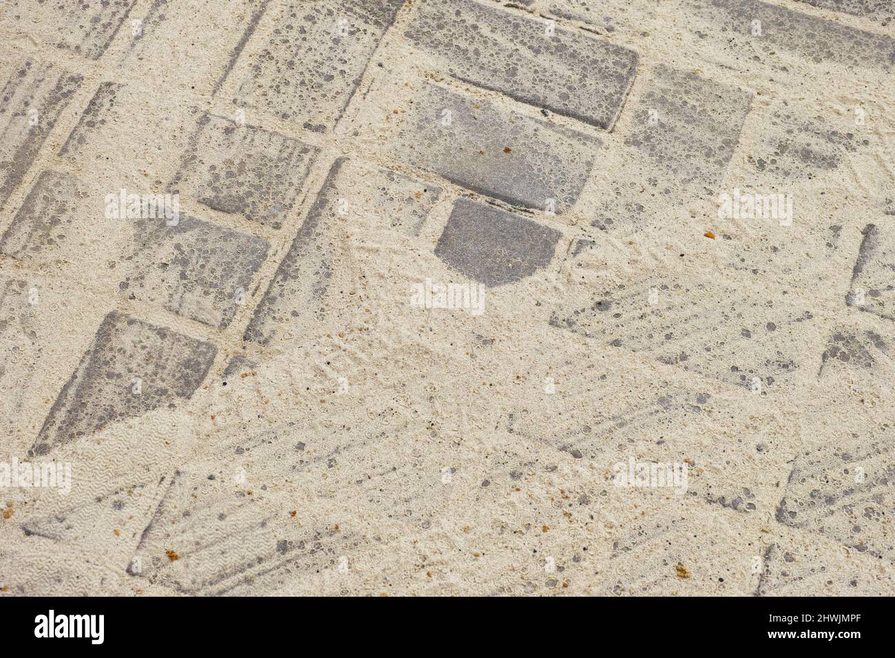 Sand laying on a stone tiles. Full frame Stock Photo - Alamy