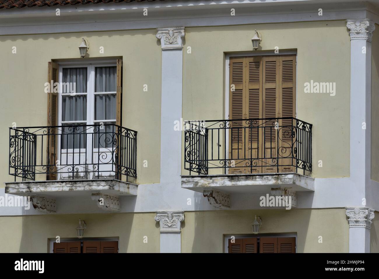 Old Neoclassical house facade with matching windows, wooden shutters ...