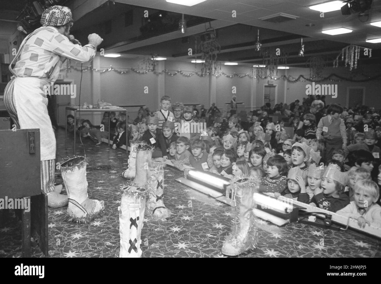 Bill Gore, the singing cobbler, entertains children at a party in the ...