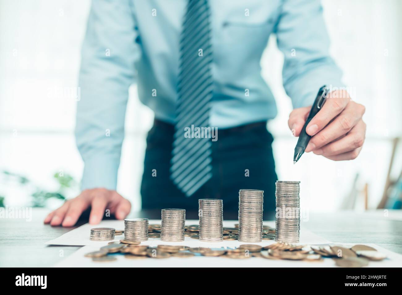 Hand putting money coins stack growing, saving money for finance ...