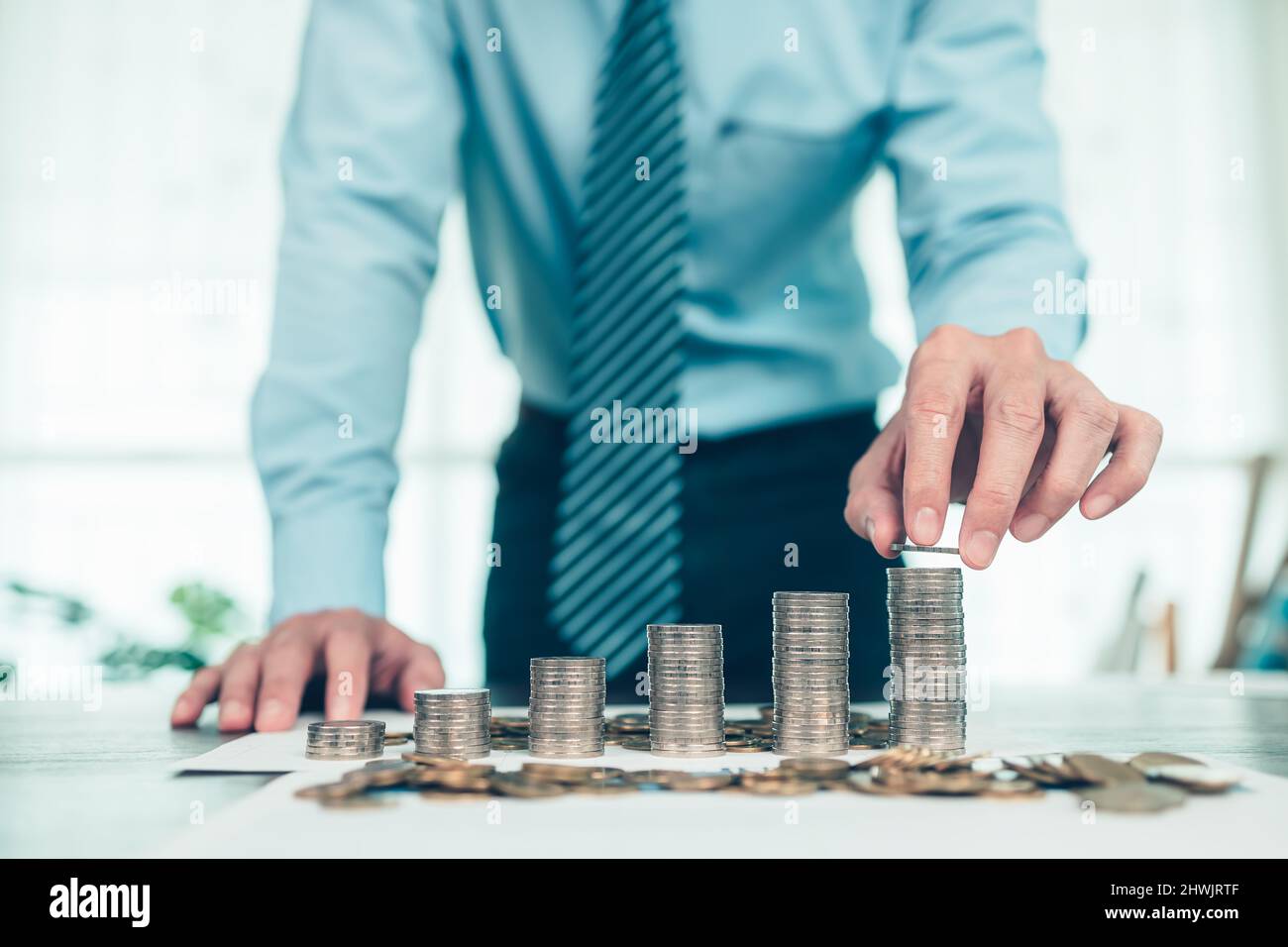 Hand putting money coins stack growing, saving money for finance ...