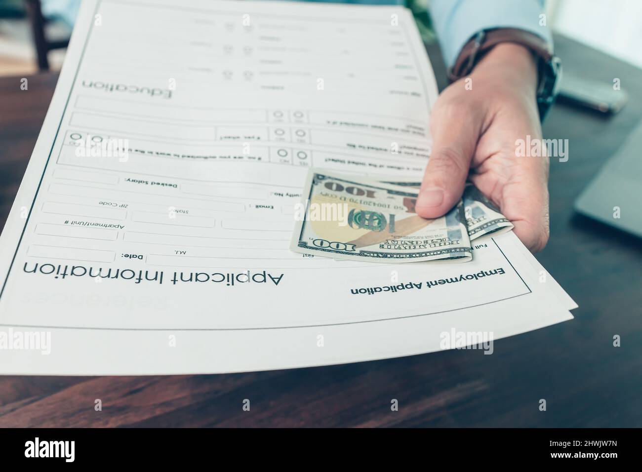Men attach money to job applications. A man bribe for a new job. job ...