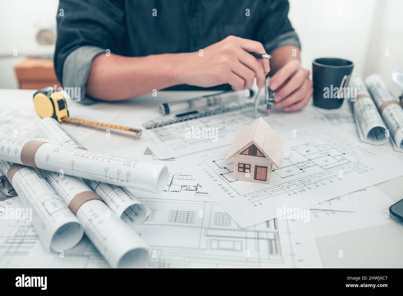 Architect engineer use compass drawing design working on bueprint ...