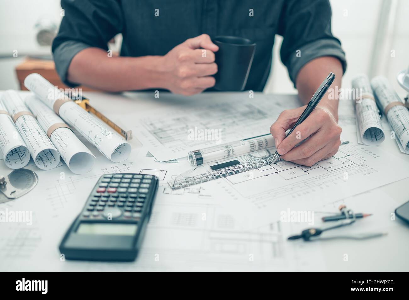 Architect engineer use pen and mini T-slide drawing design working on ...