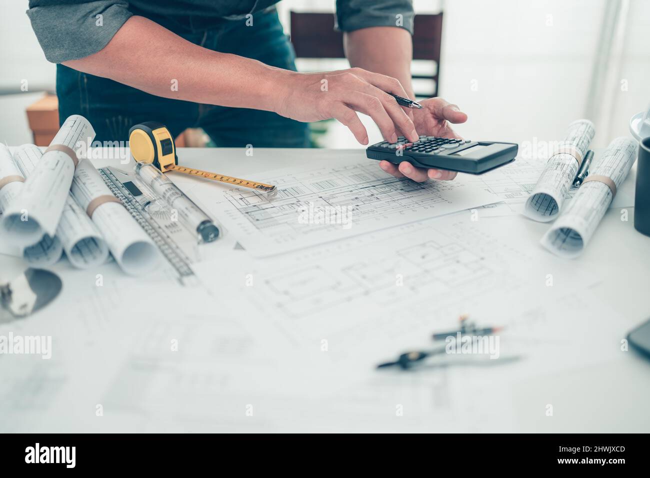Architect engineer use calculator for calculate drawing design working ...