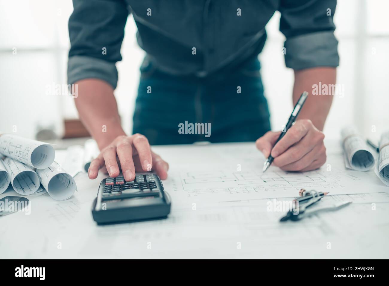 Architect engineer use calculator for calculate drawing design working ...