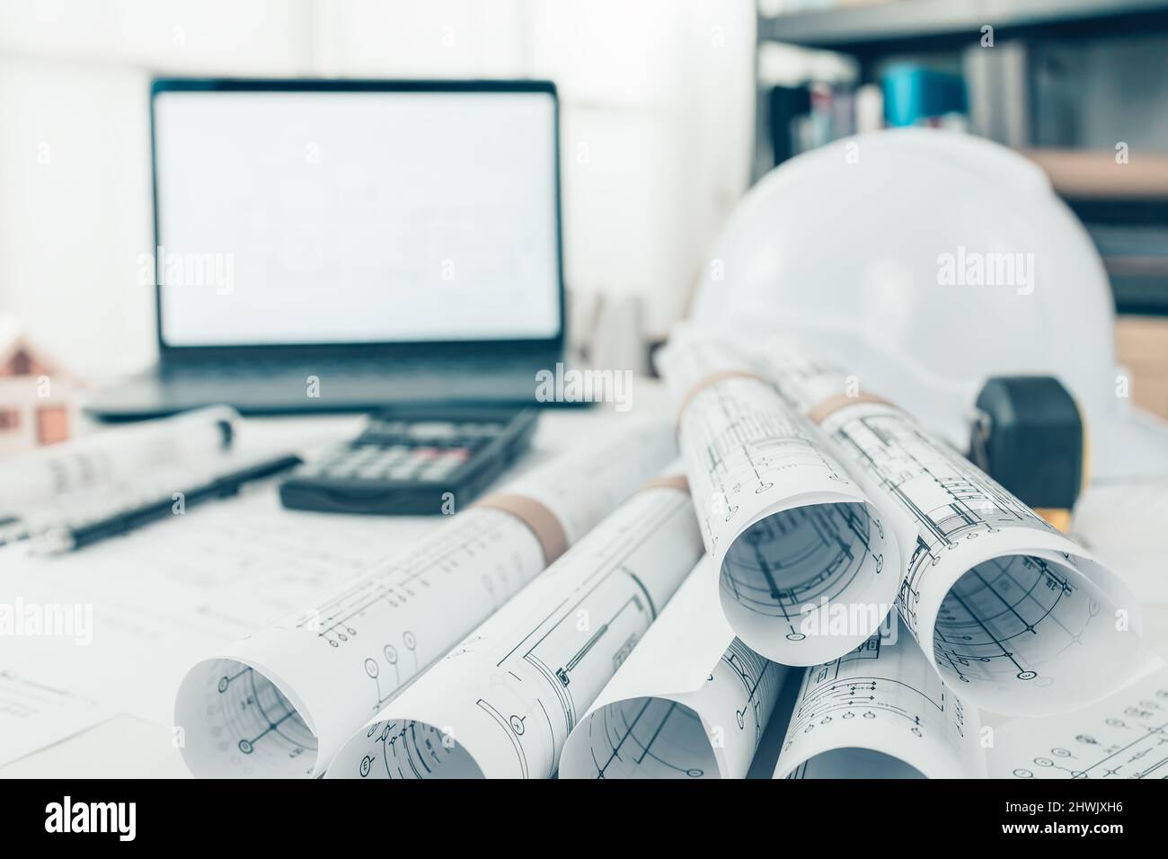 Mini model house, pencil, protractor, tape measure, compass, laptop and ...