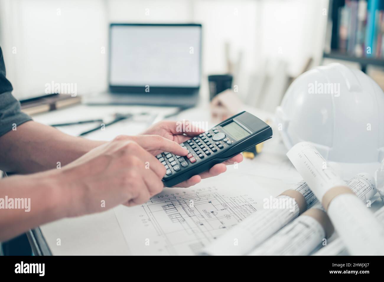 Architect engineer use calculator for calculate drawing design working ...