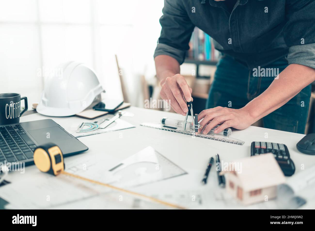 Architect engineer use compass drawing design working on bueprint ...
