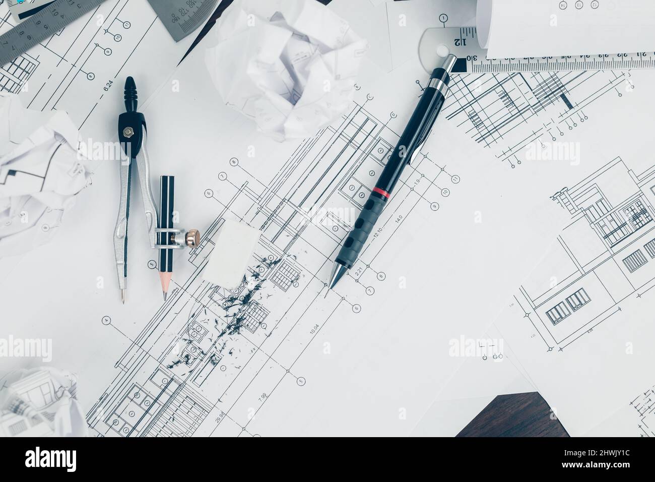 eraser crumbs, compass and pencil on drawing design working on bueprint ...