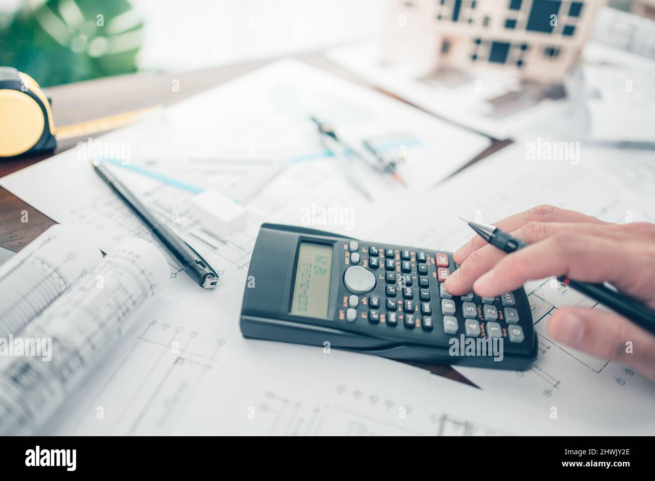 Architect engineer use calculator for calculate drawing design working ...