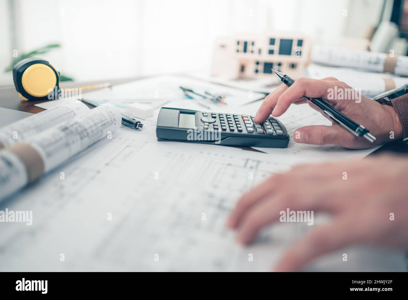 Architect engineer use calculator for calculate drawing design working ...