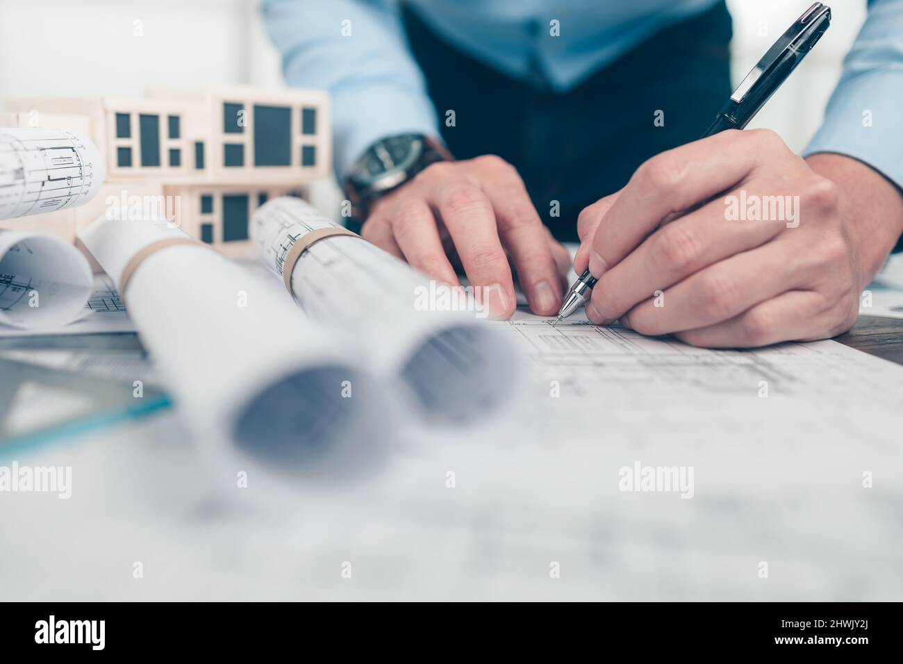 Architect engineer use pen drawing design working on bueprint. House planning design and ...