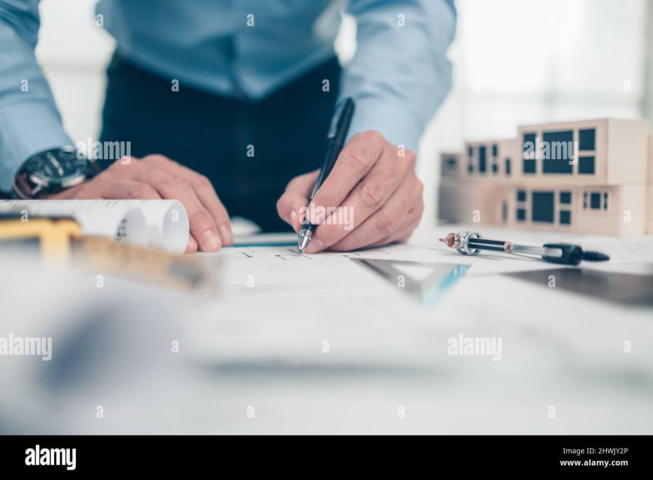 Architect engineer use pen drawing design working on bueprint. House planning design and ...