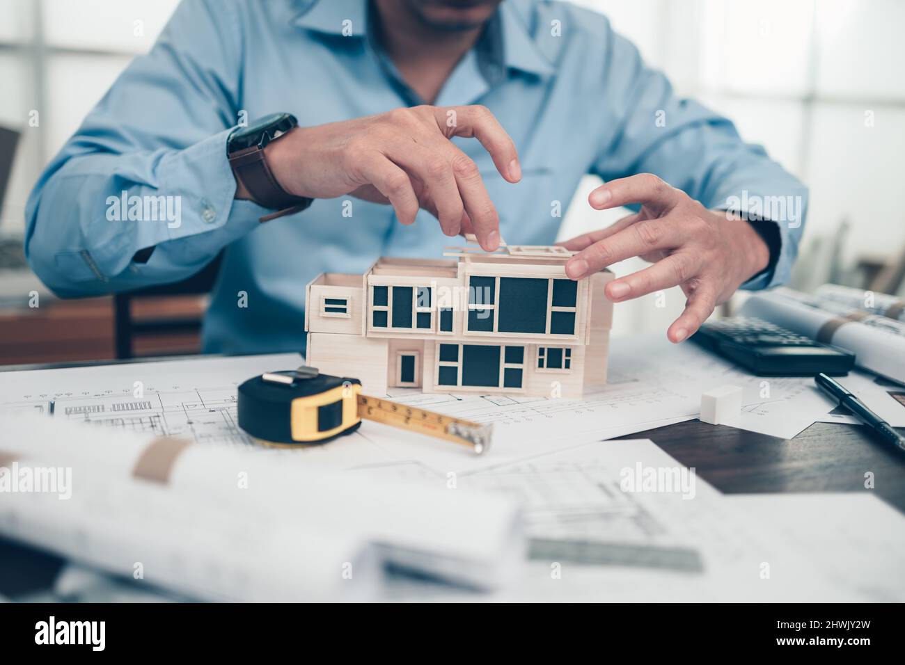 Architect engineer design house model on bueprint. House planning ...