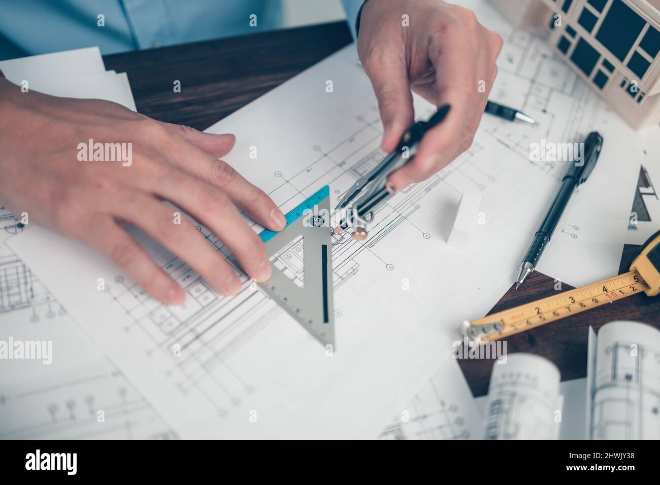 Architect engineer use compass and triangular angle ruler drawing ...