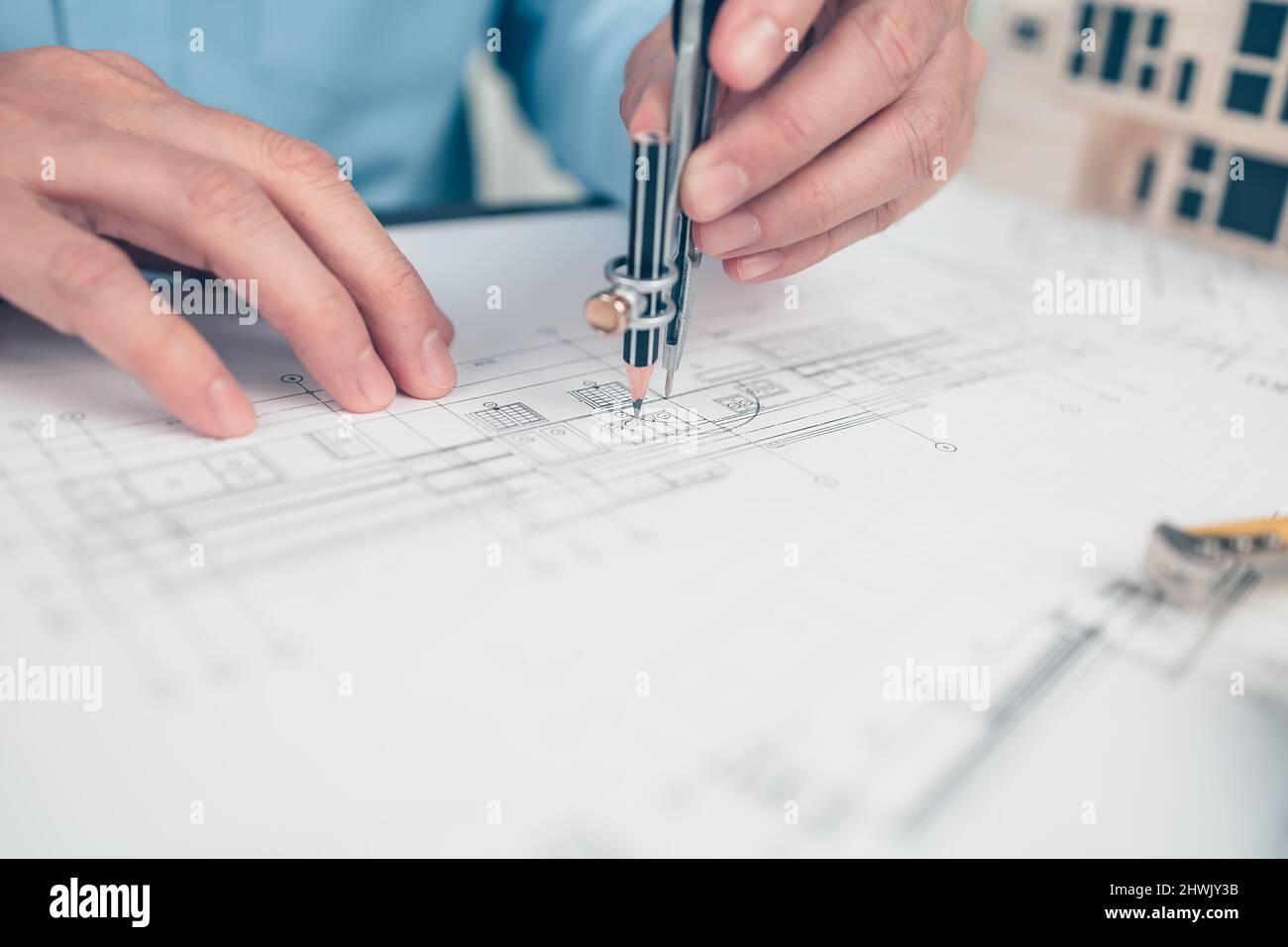Architect engineer use compass drawing design working on bueprint ...