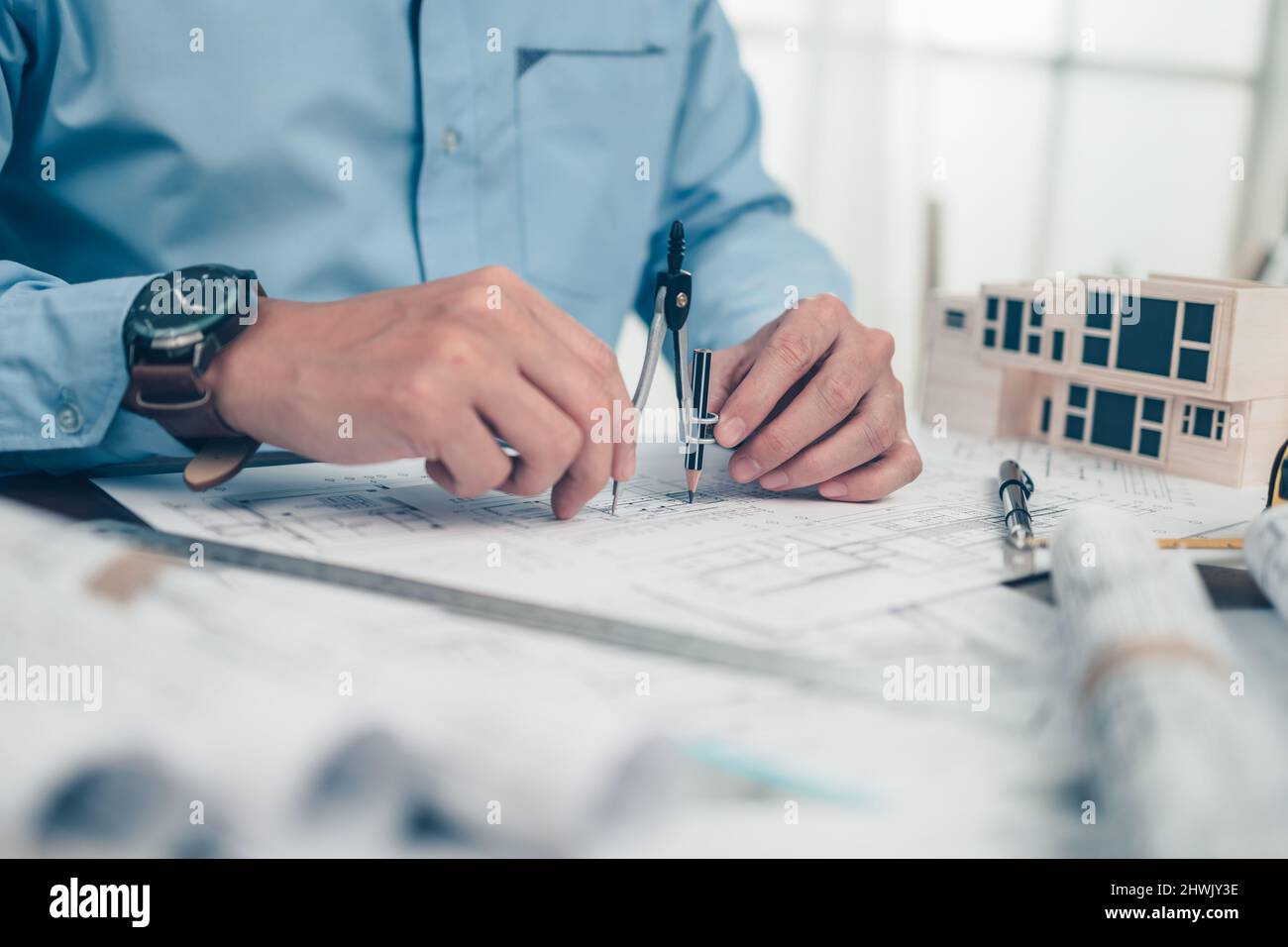 Architect engineer use compass drawing design working on bueprint ...