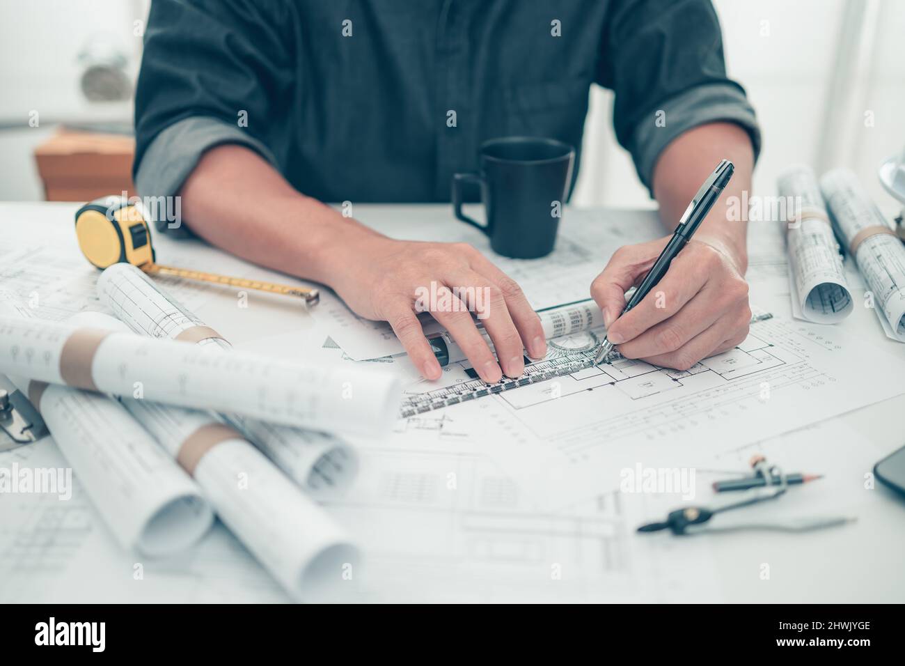 Architect engineer use pen and mini T-slide drawing design working on ...