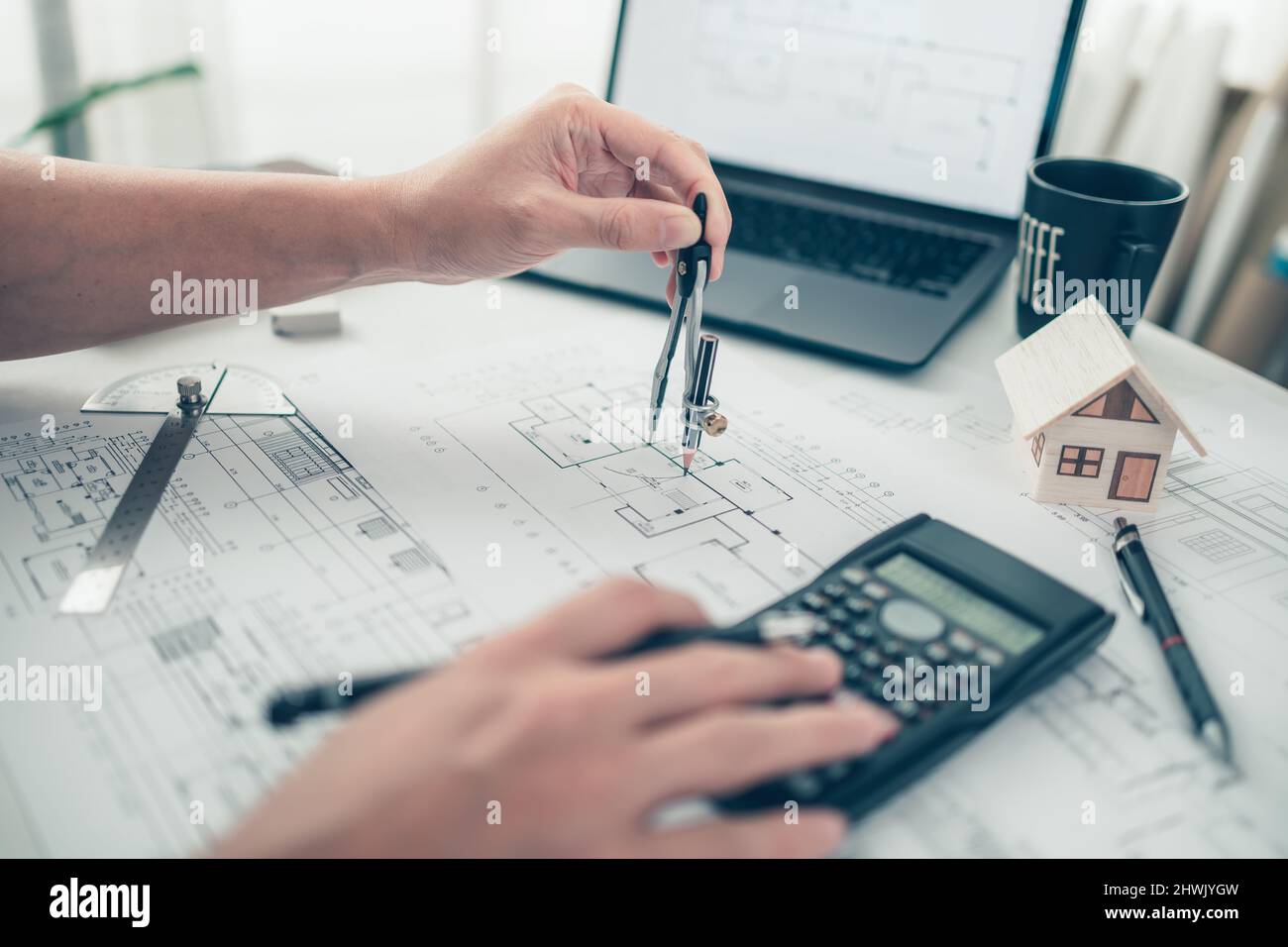 Architect engineer use compass drawing design working on bueprint ...