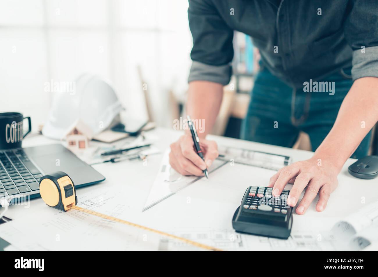 Architect engineer use calculator for calculate drawing design working ...