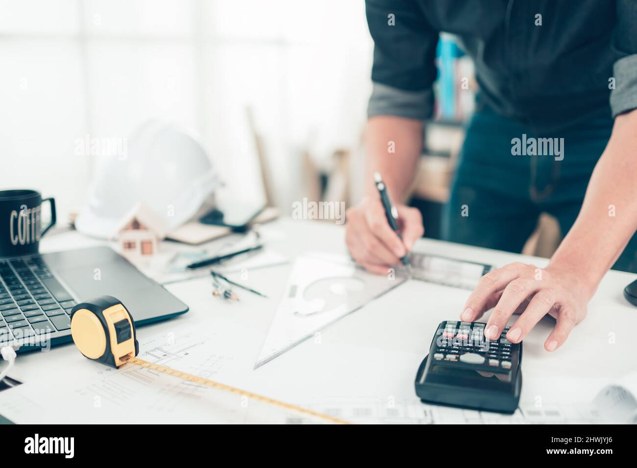 Architect engineer use calculator for calculate drawing design working ...