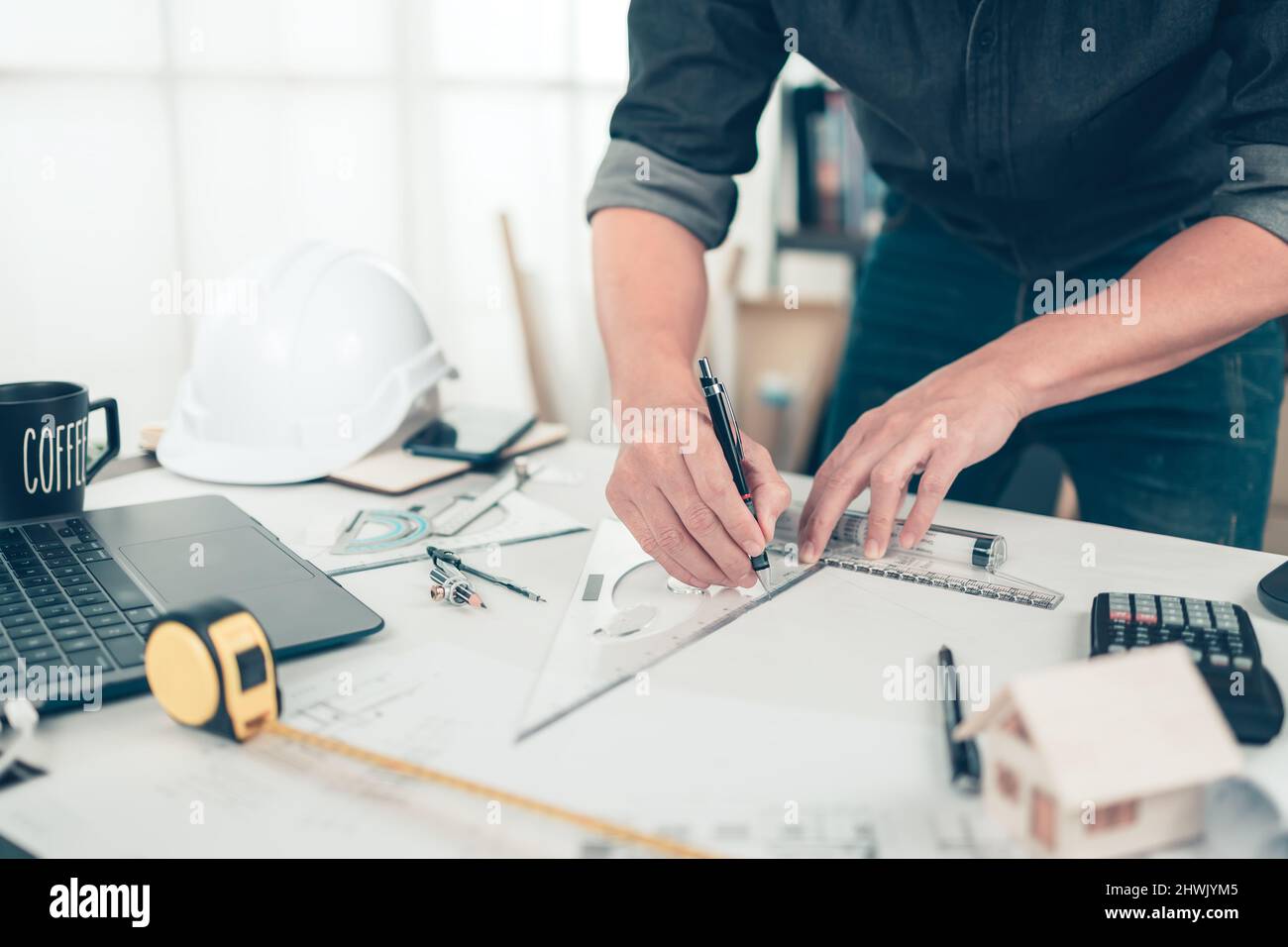 Architect engineer use pen and angle protector drawing design working ...