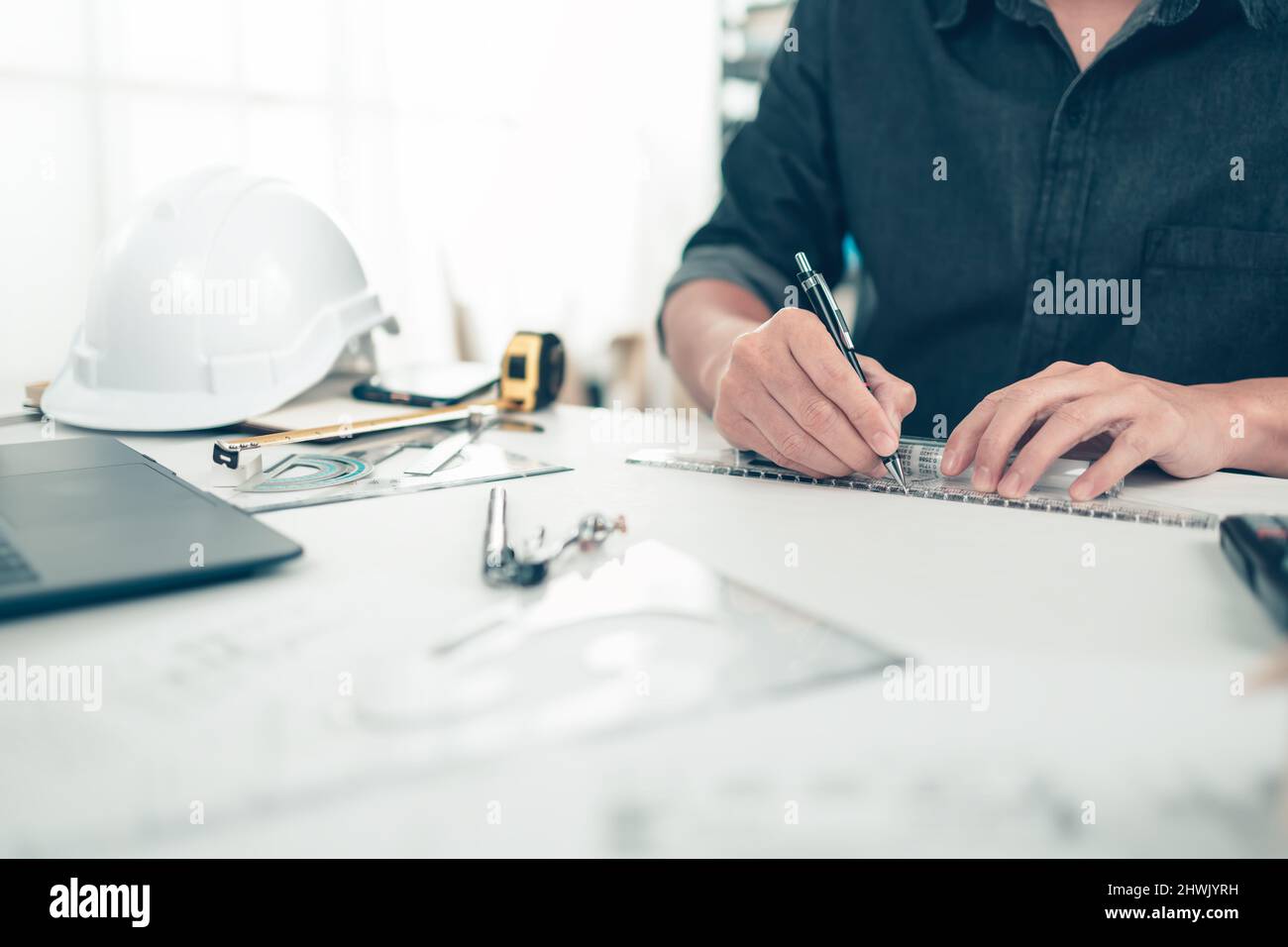 Architect engineer use pen and mini T-slide drawing design working on ...