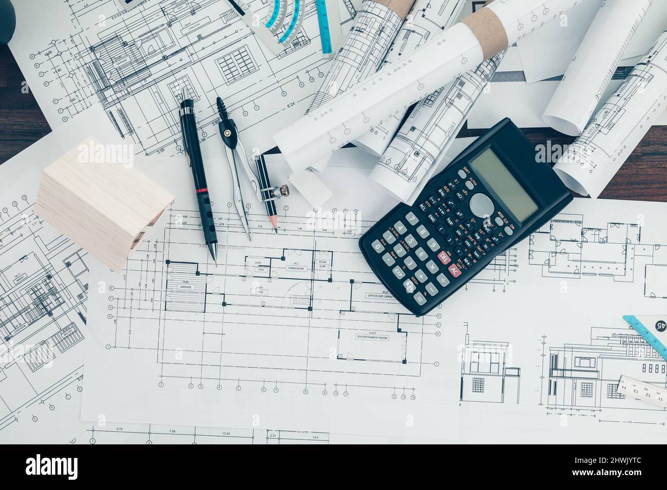 Mini model house, pencil, compass and roll blueprint plan on blueprint ...