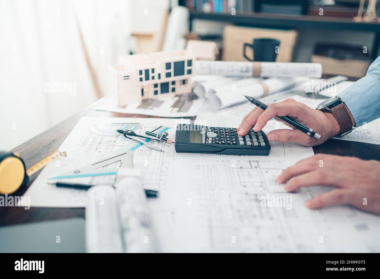 Architect engineer use calculator for calculate drawing design working ...