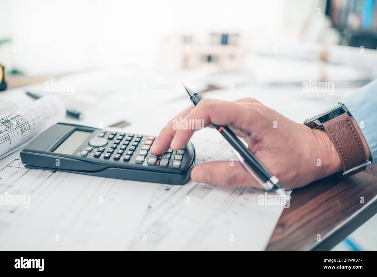Architect engineer use calculator for calculate drawing design working ...