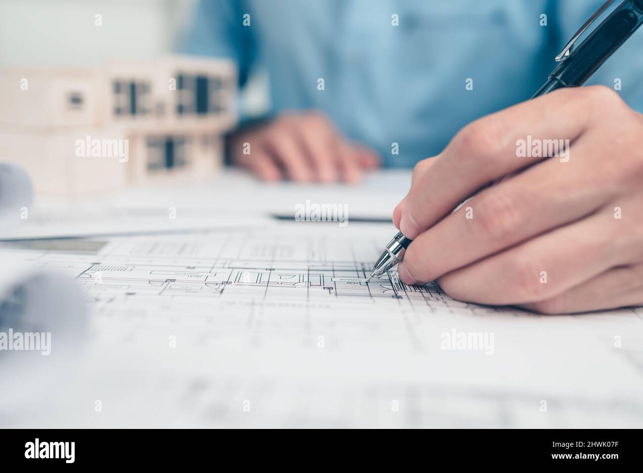 Architect engineer use pen drawing design working on bueprint. House planning design and ...