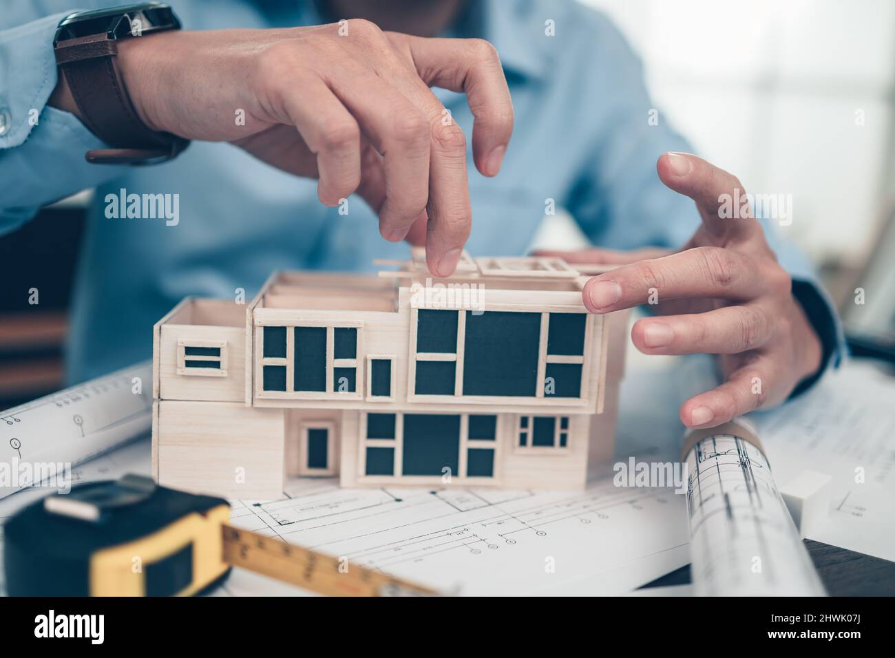 Architect engineer design house model on bueprint. House planning design and construction ...