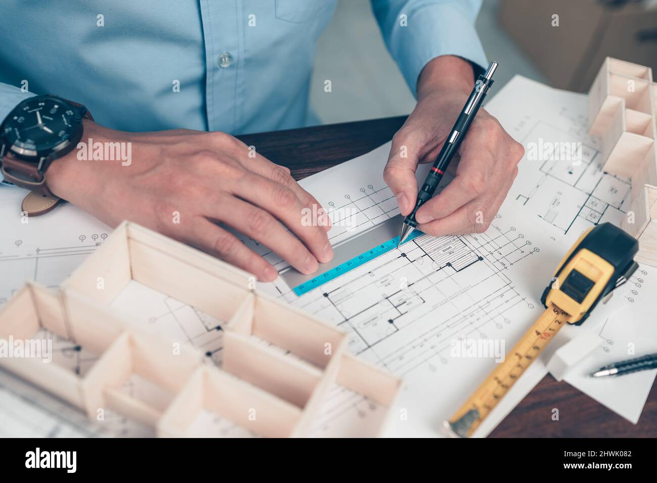 Architect engineer use pen and ruler drawing design working and tape measure on bueprint. House ...