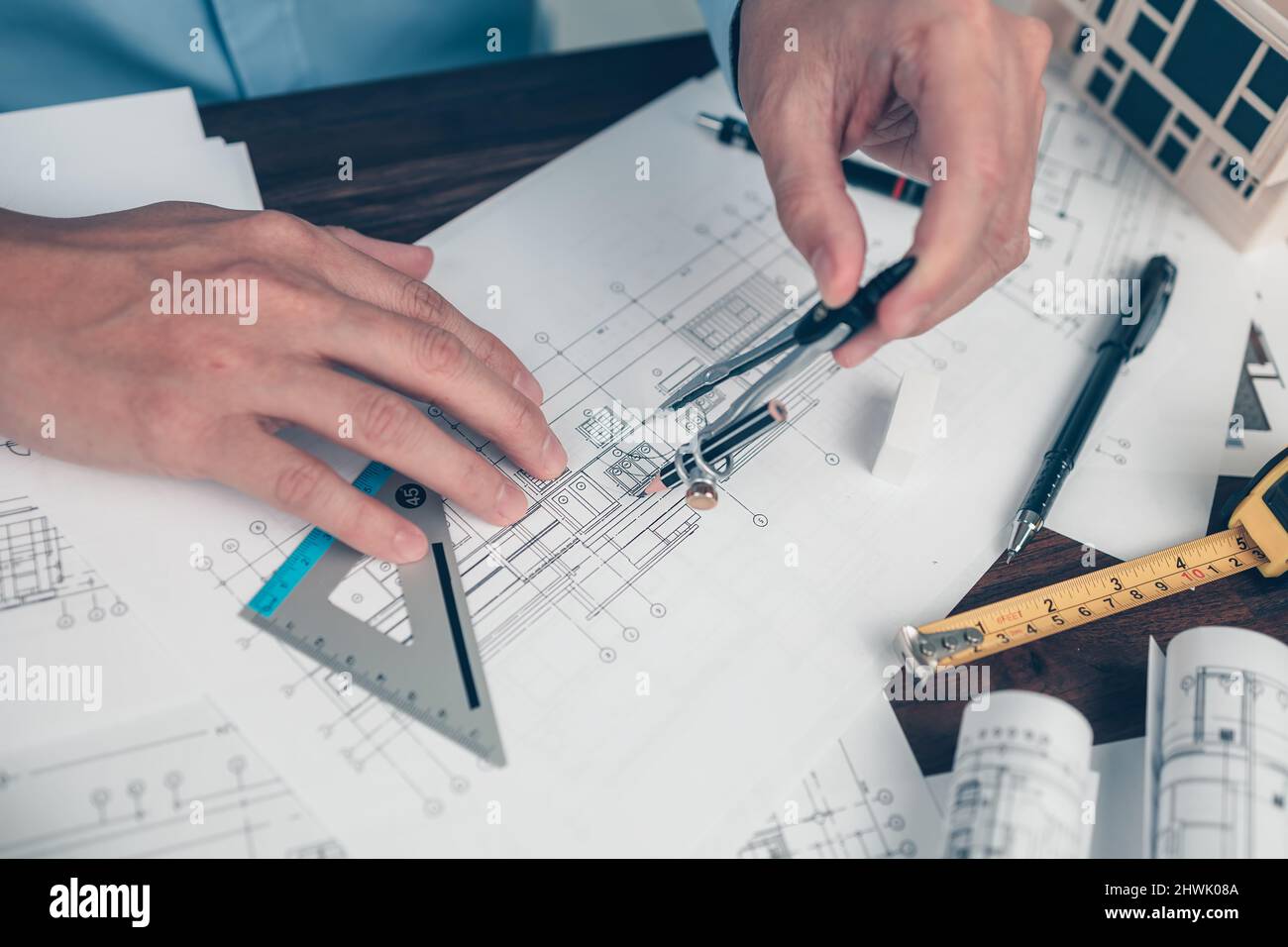 Architect engineer use compass drawing design working on bueprint ...