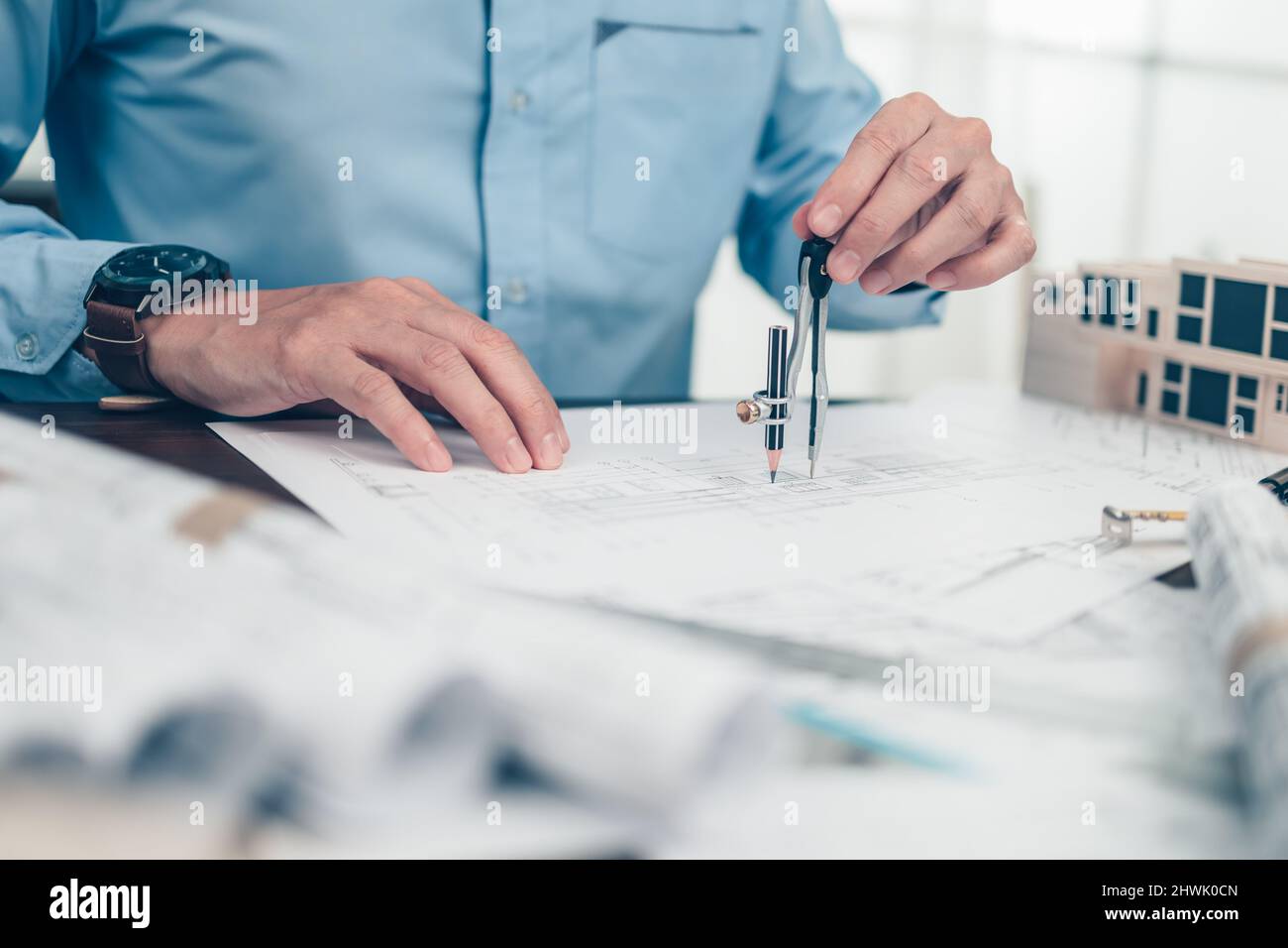 Architect engineer use compass drawing design working on bueprint ...