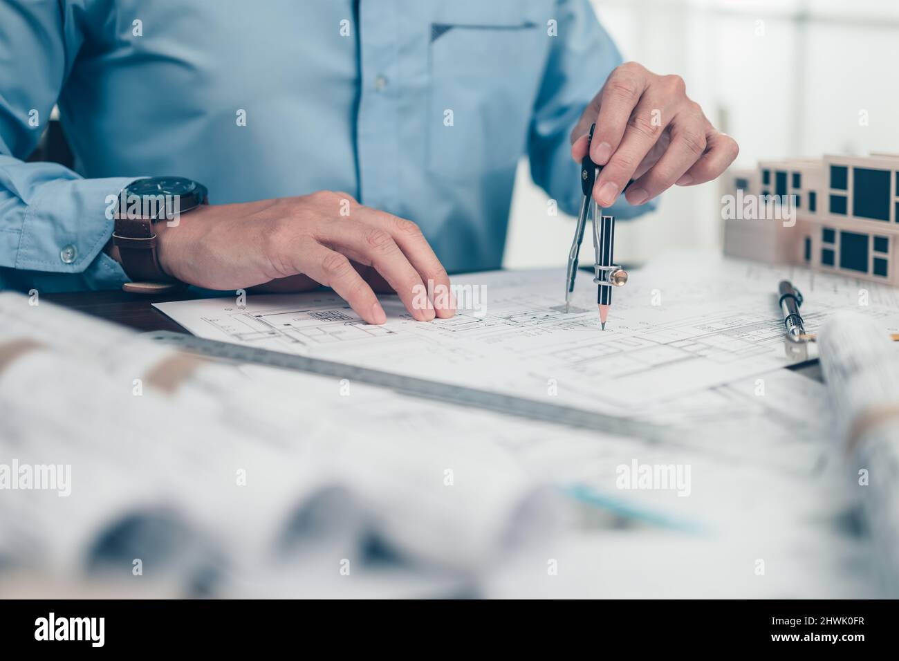 Architect engineer use compass drawing design working on bueprint ...