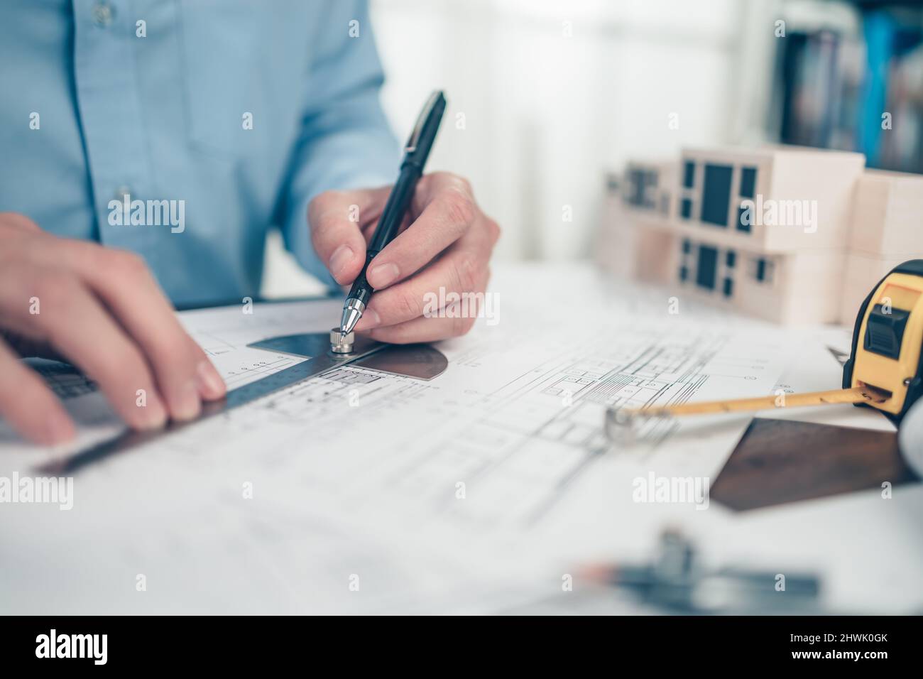 Architect engineer use pen and angle protector drawing design working ...
