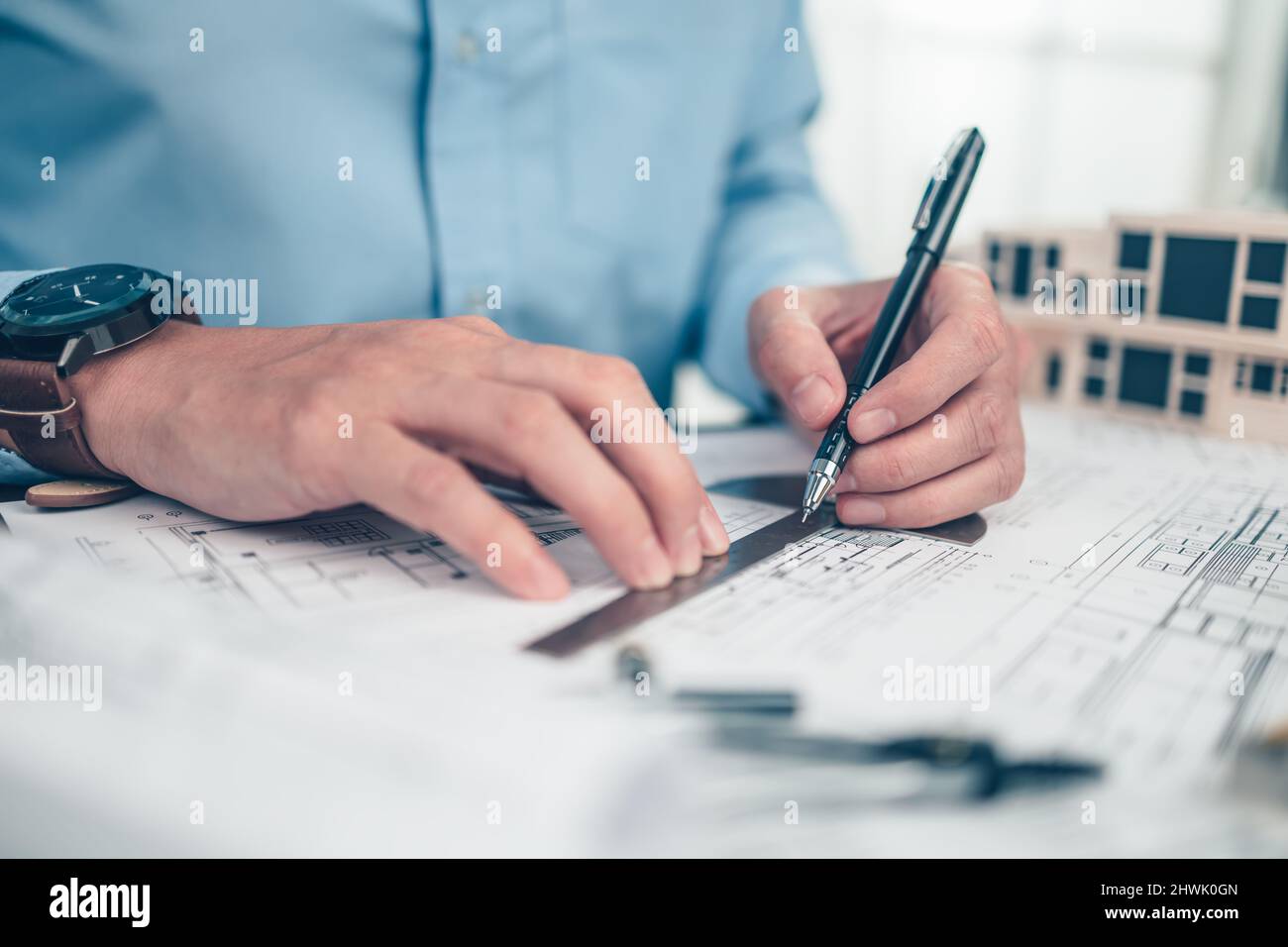 Architect engineer use pen and angle protector drawing design working ...