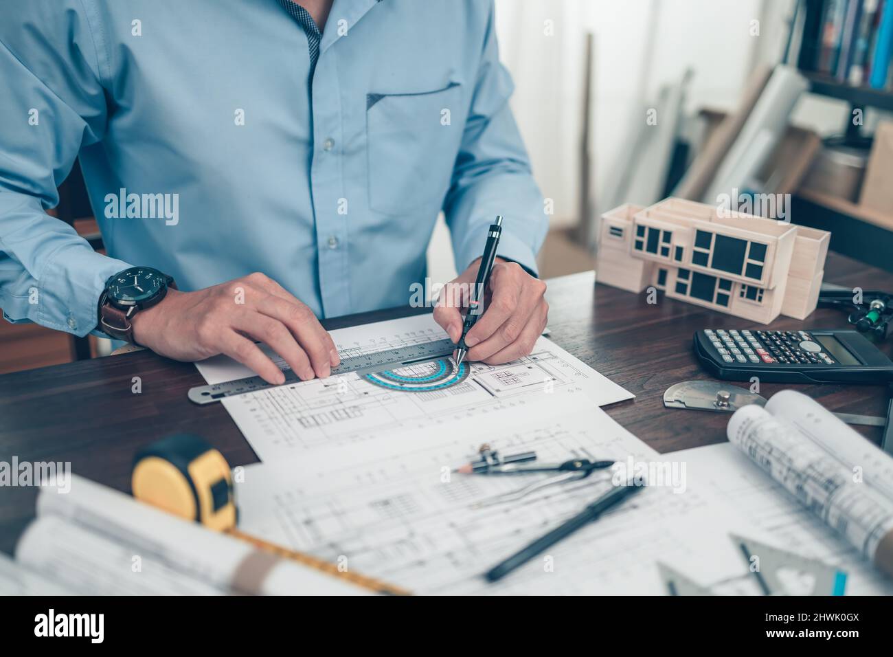Architect engineer use pen and angle protector drawing design working ...