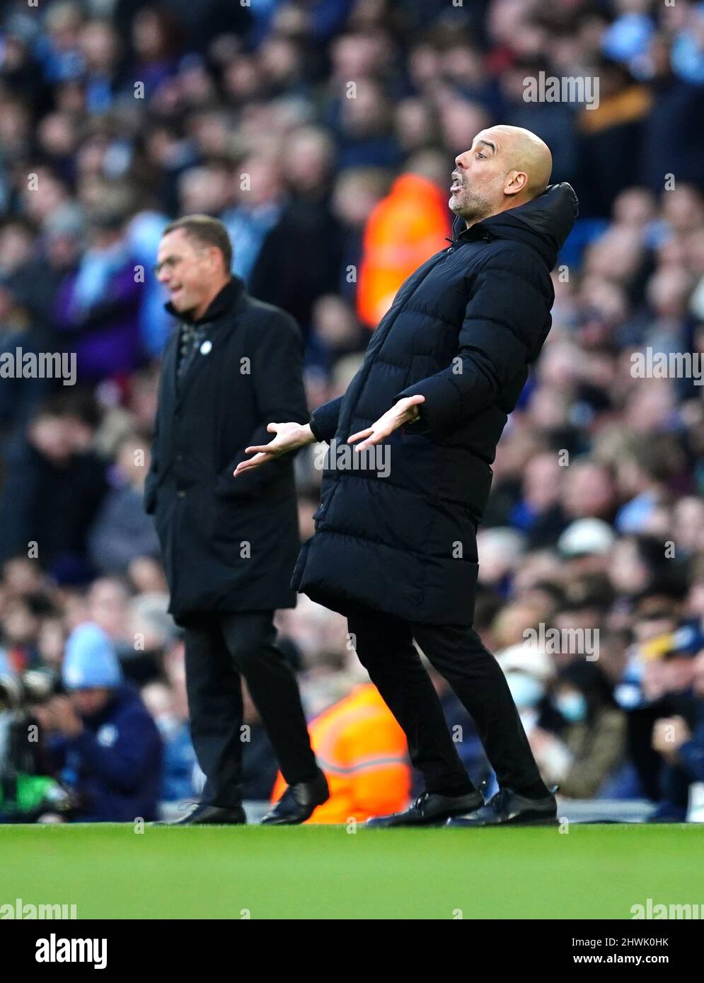 Manchester City manager Pep Guardiola (right) gestures on the touchline ...