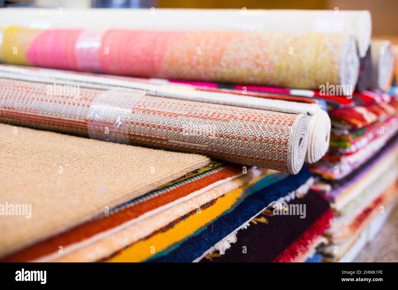 Stack of traditional colorful carpets in carpet shop Stock Photo - Alamy