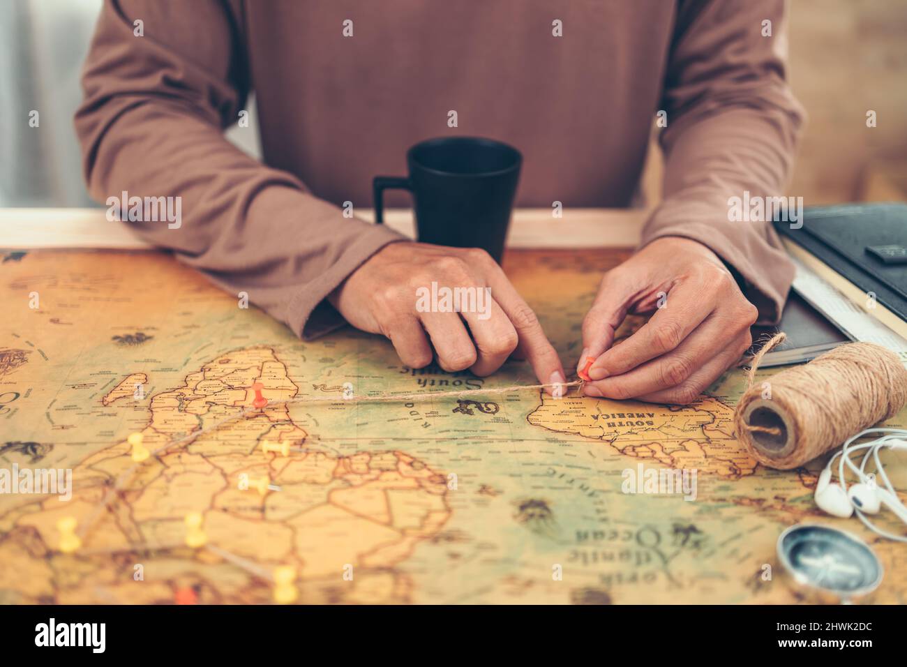 Tourist planning vacation, holiday with the help world map. Man's hand ...