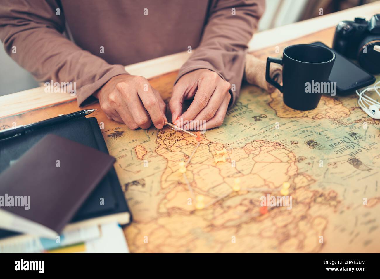 Tourist planning vacation, holiday with the help world map. Man's hand ...