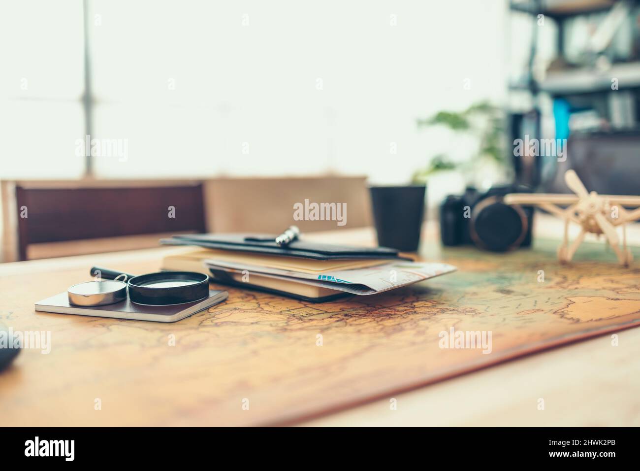 Road map insert in book, compass, magnifying glass and passport on ...