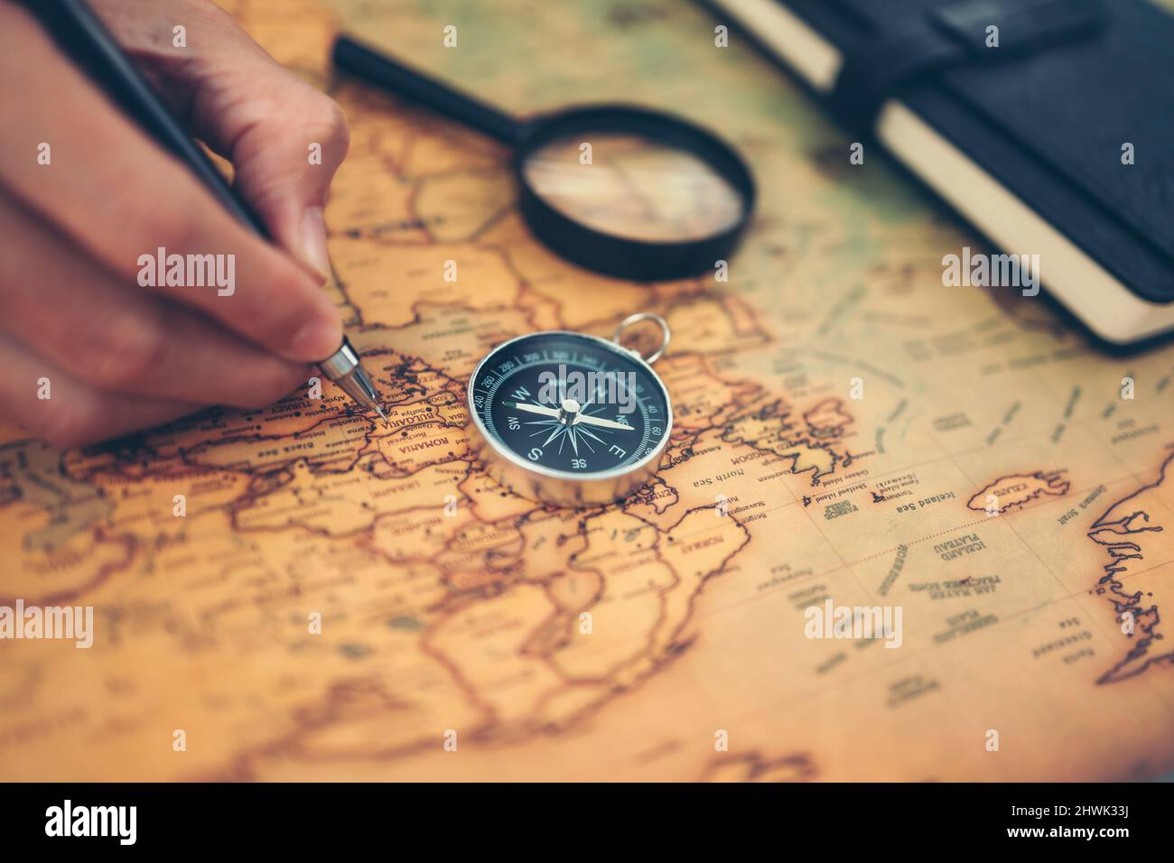 Hand use pen and marking and Magnetic compass, magnifying glass and ...