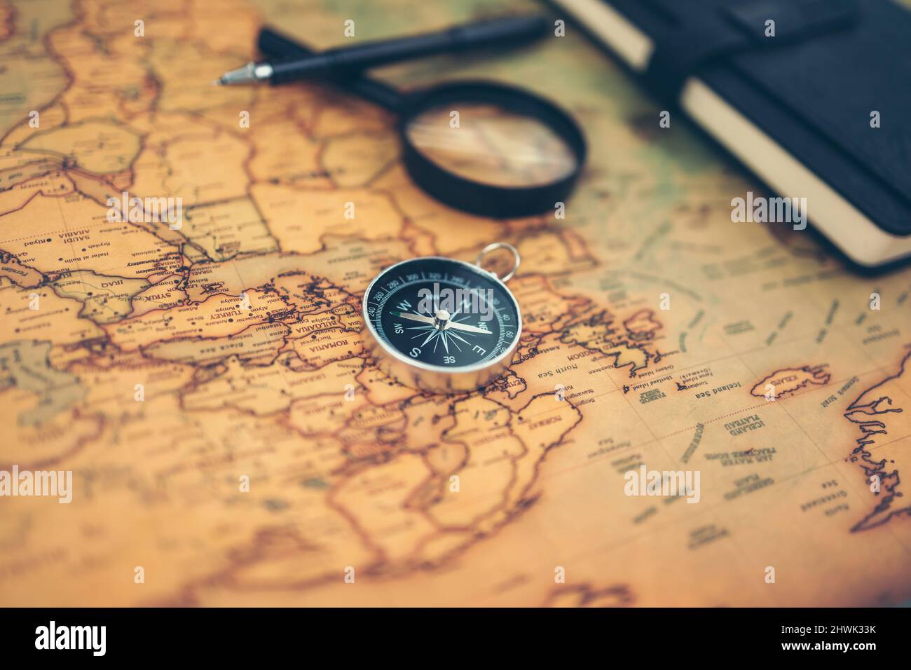 Magnetic compass, magnifying glass and diary on world map. Travel ...
